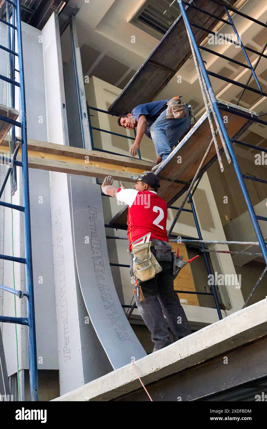 Mexican construction workers finishing interior house Stock Photo - Alamy