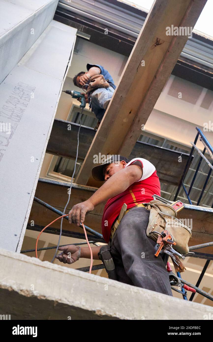 Mexican construction workers finishing interior house Stock Photo - Alamy