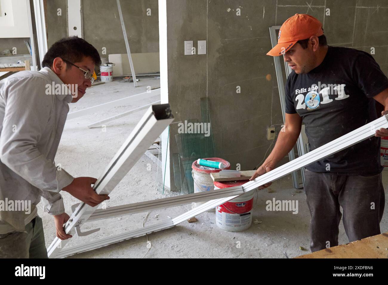 Mexican construction workers finishing interior house Stock Photo - Alamy