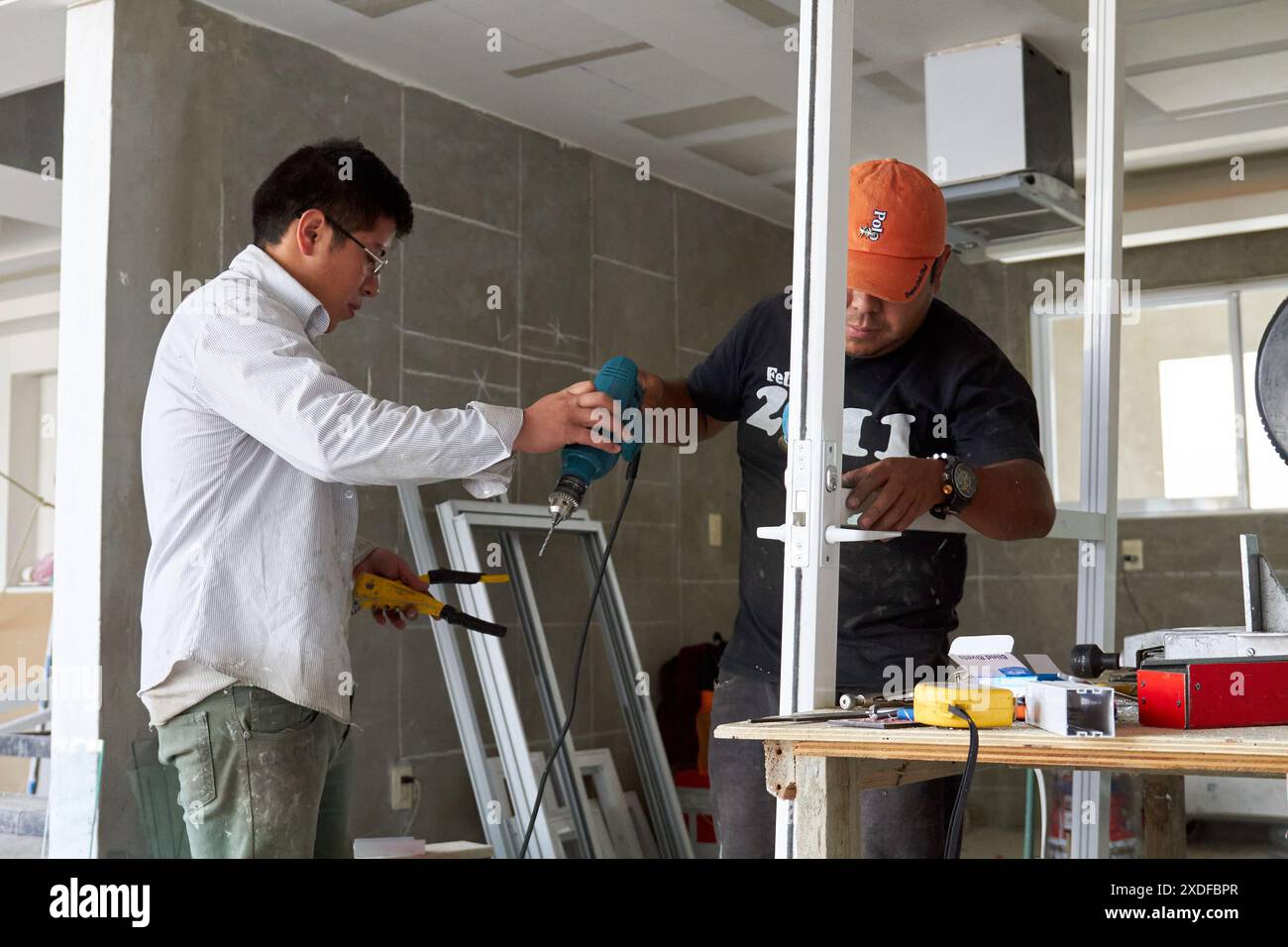 Mexican construction workers finishing interior house Stock Photo - Alamy