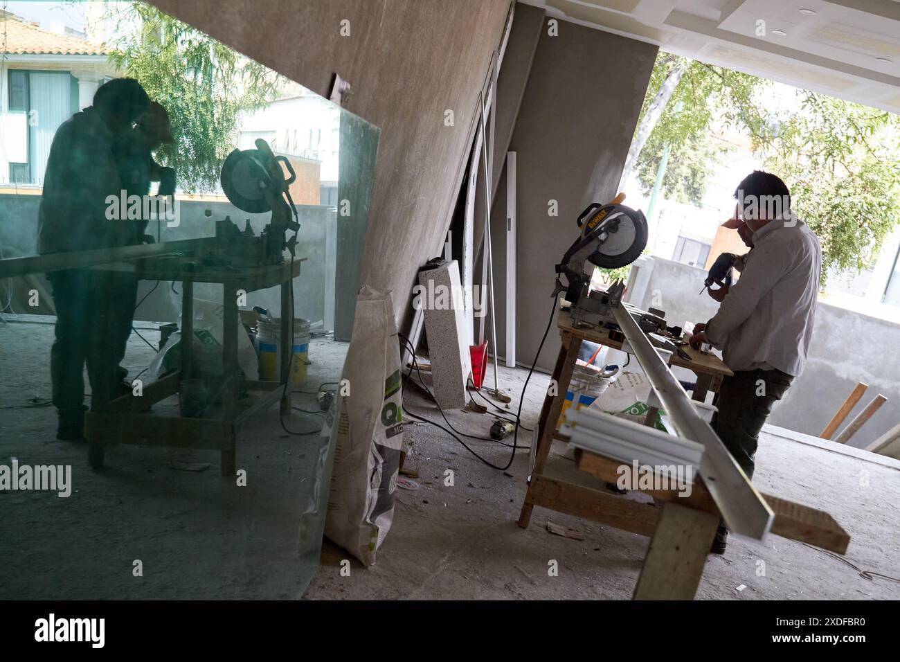 Mexican construction workers finishing interior house Stock Photo - Alamy
