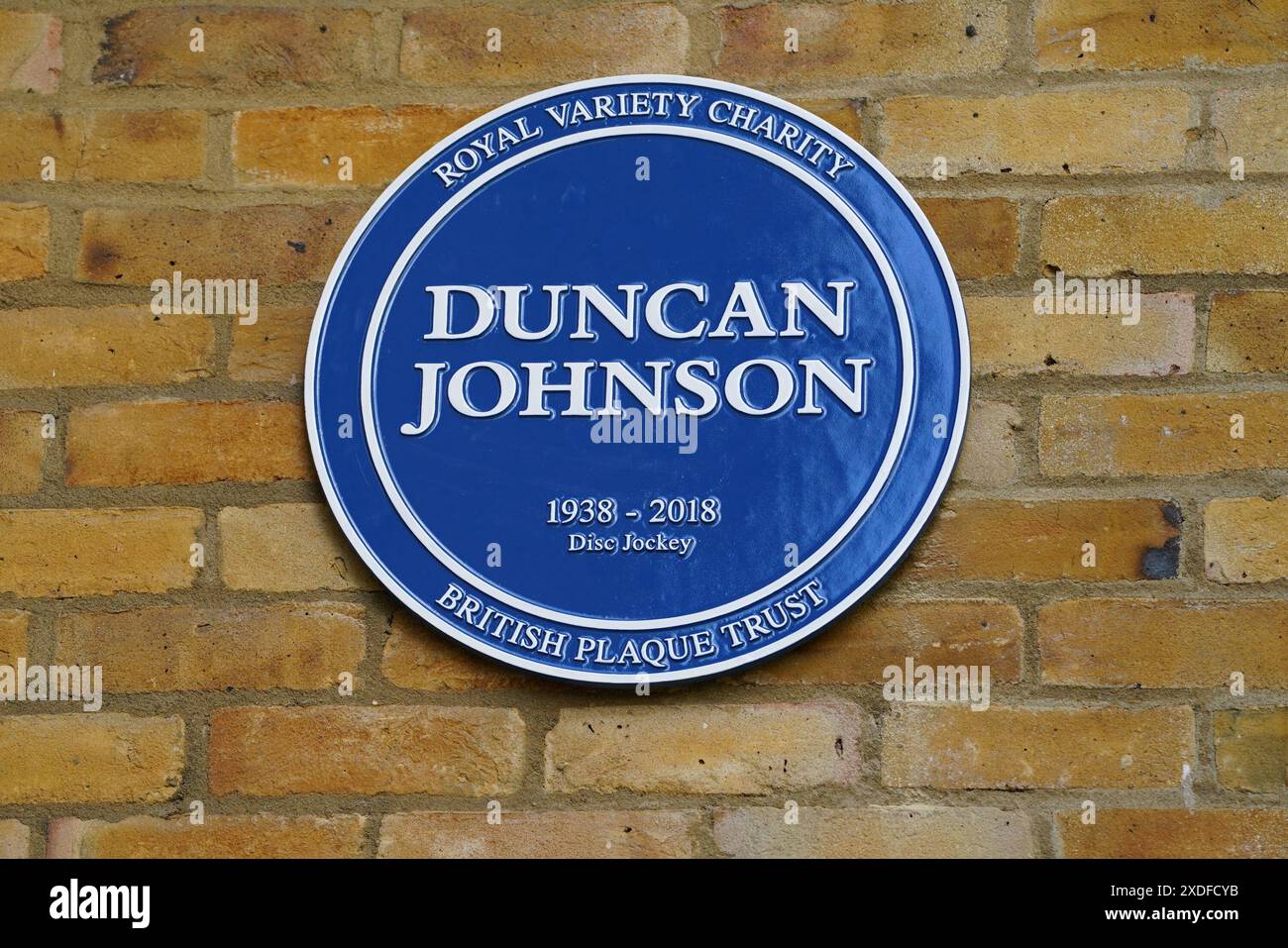 A blue plaque commemorating Duncan Johnson unveiled during a ceremony ...
