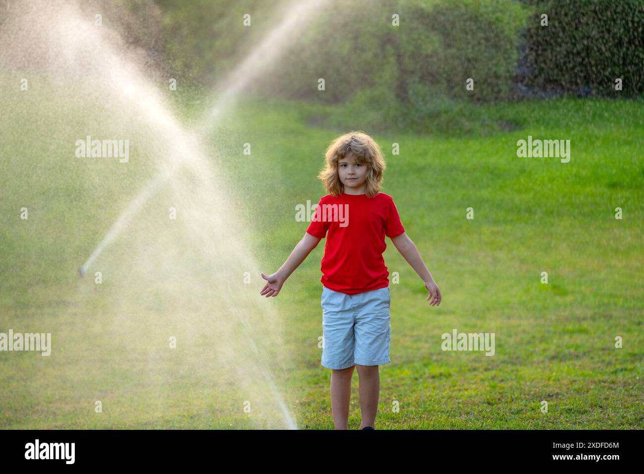 Cute little kid play in garden at summer day. Child enjoy summer in ...