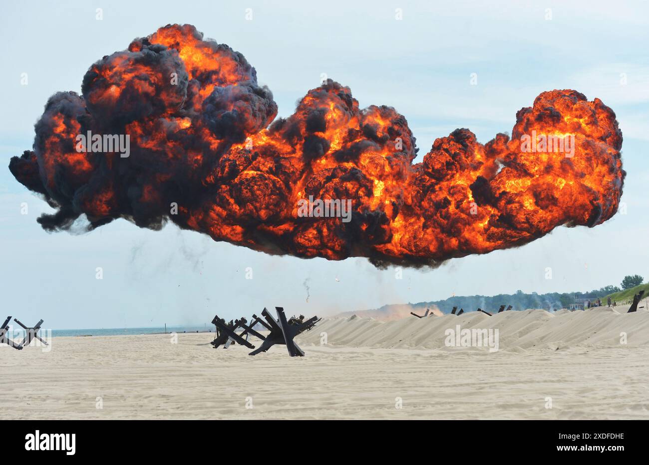 Pyrotechnics are set off as reenactors attack German positions Saturday ...