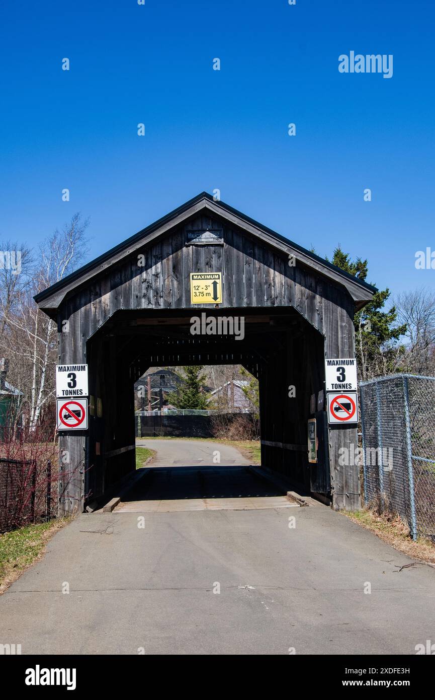 Entrance to the wooden covered bridge at the wharf village at Magnetic ...