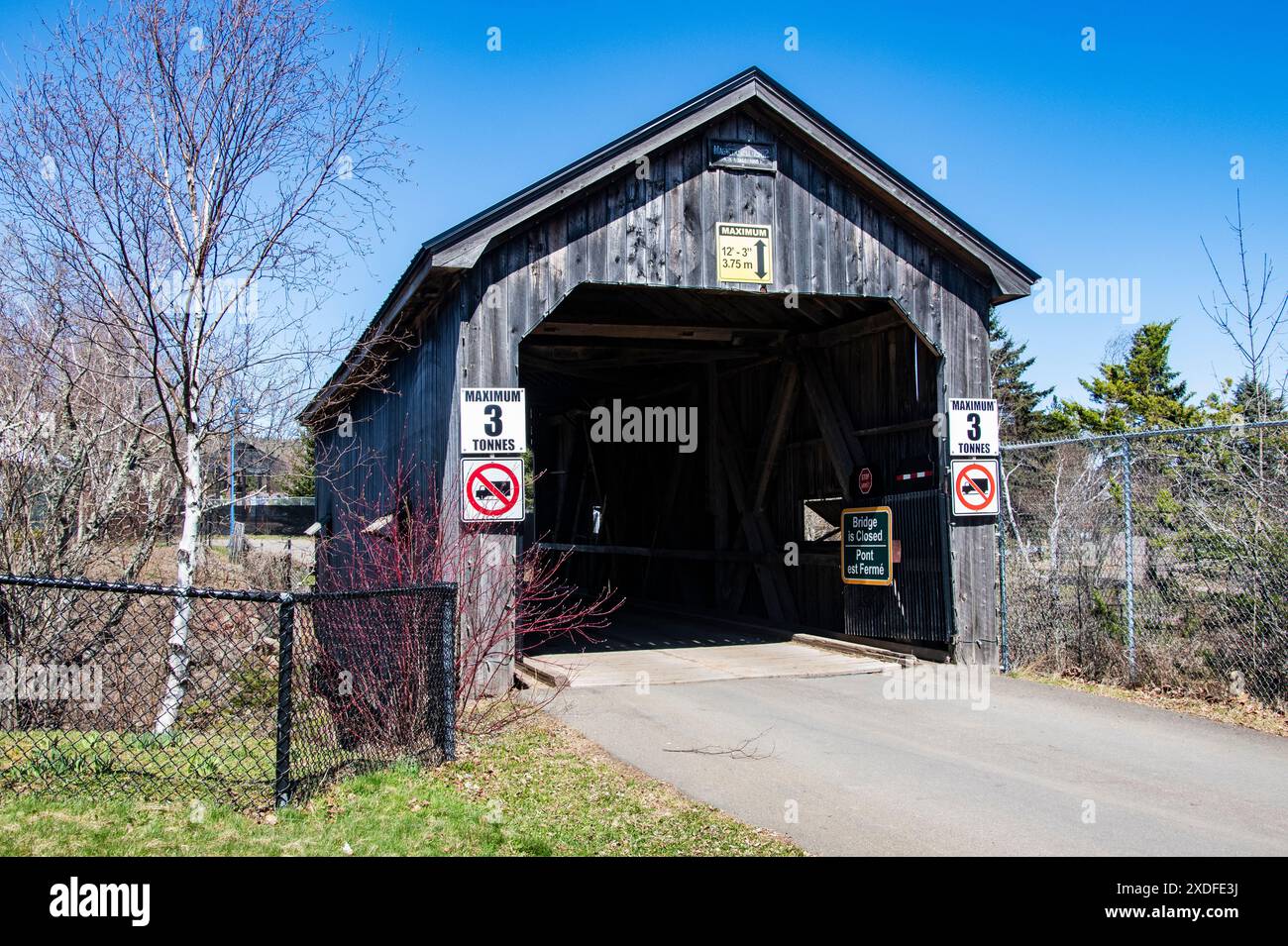 Entrance to the wooden covered bridge at the wharf village at Magnetic ...