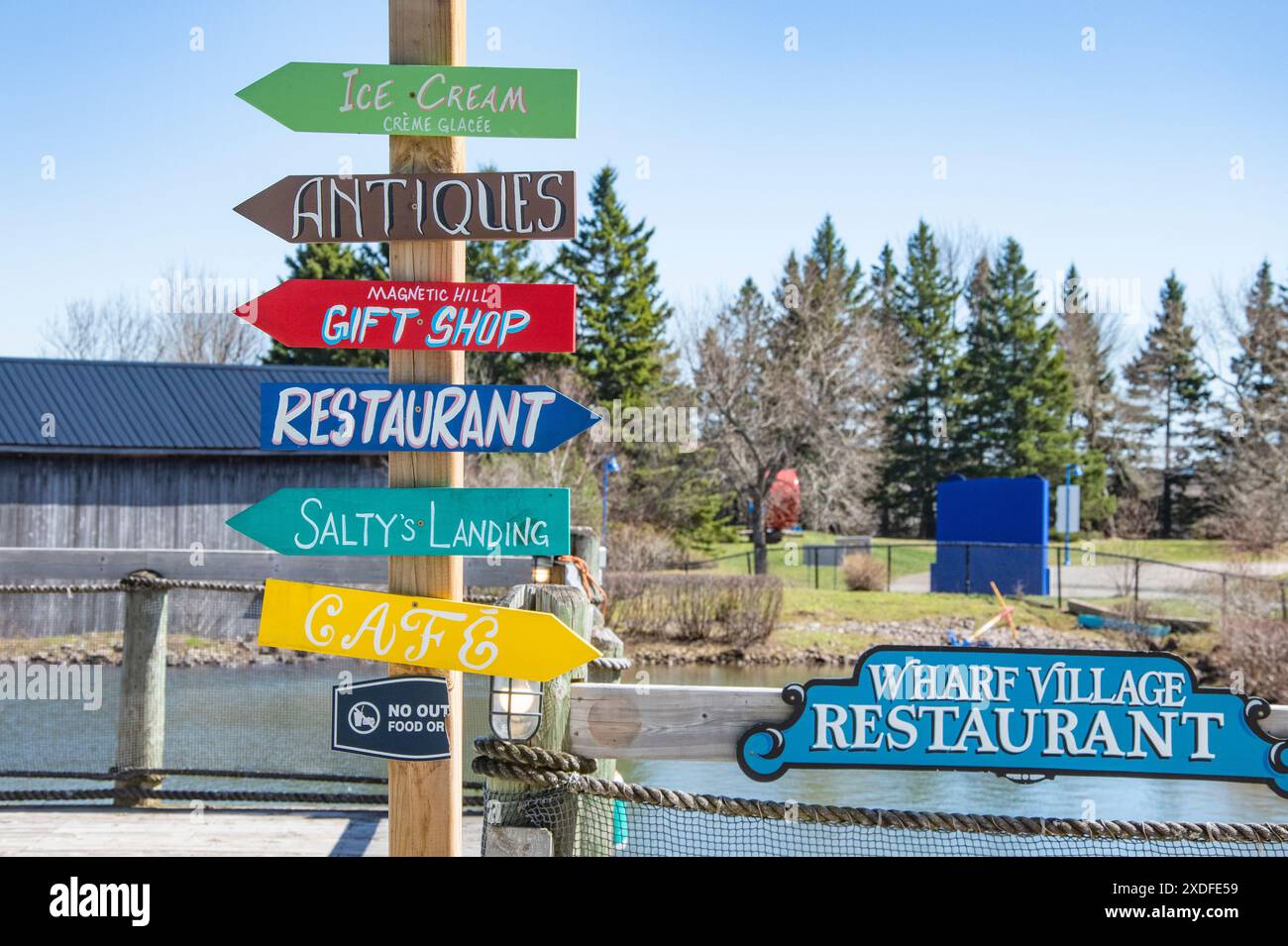 Colorful directional street signs at the wharf village at Magnetic Hill ...