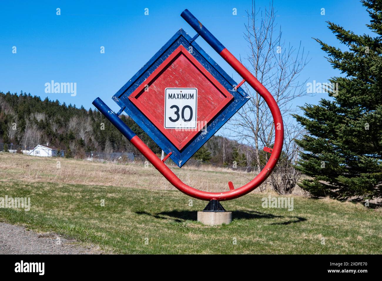 Speed limit sign in the shape of a magnet at Magnetic Hill in Moncton ...