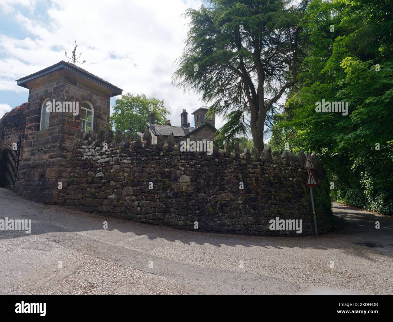 Quaint stone built mansion house with high stone wall in Biddulph ...