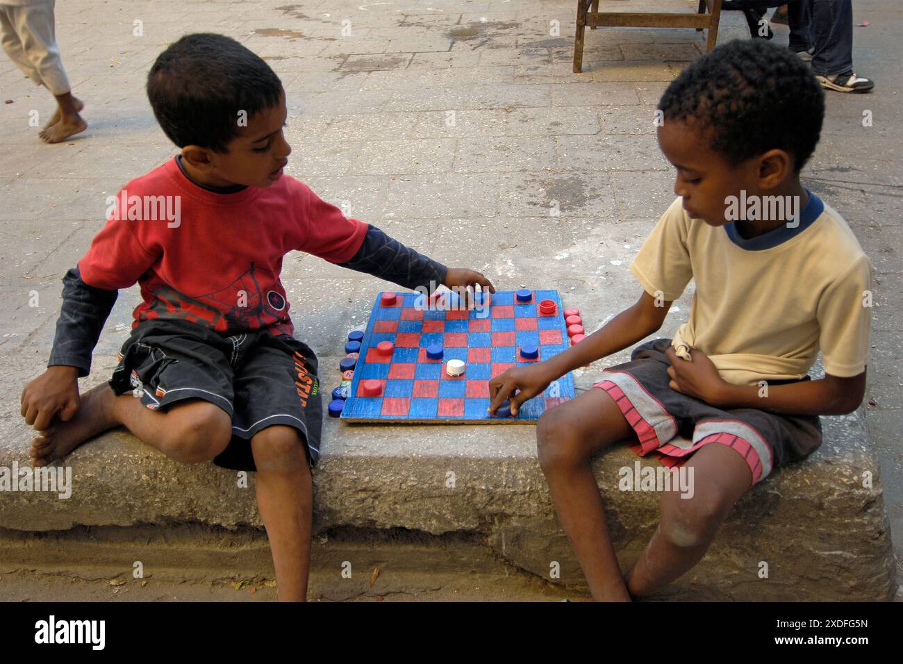 Africa Tanzania Zanzibar Stone Town Children playing checkers with ...