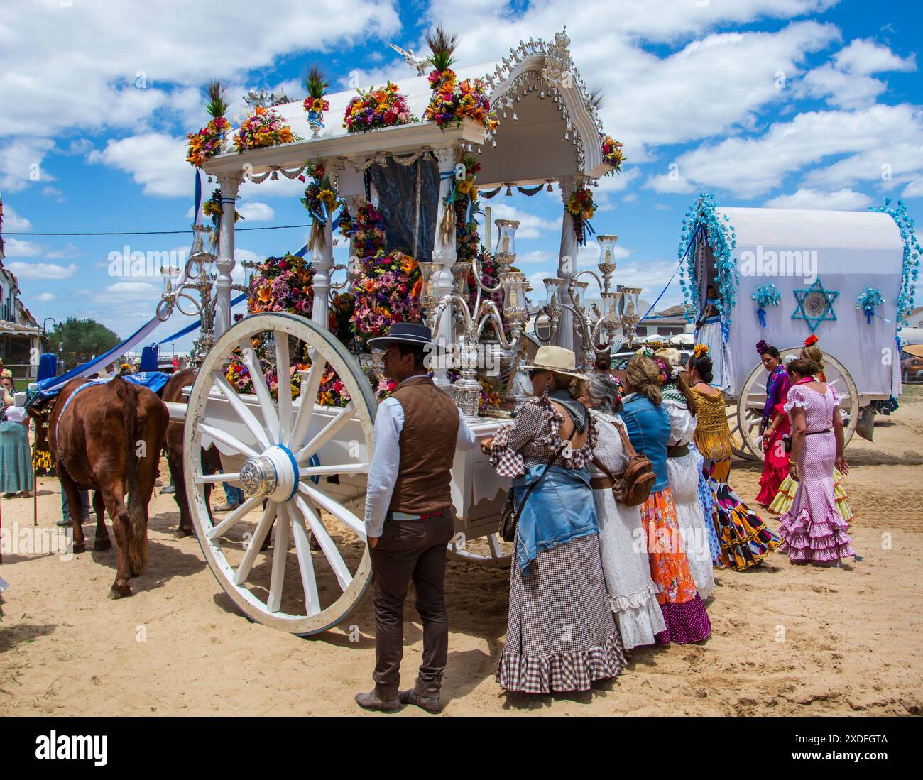 Group of pilgrims on foot following the ox cart at the entrance to ...