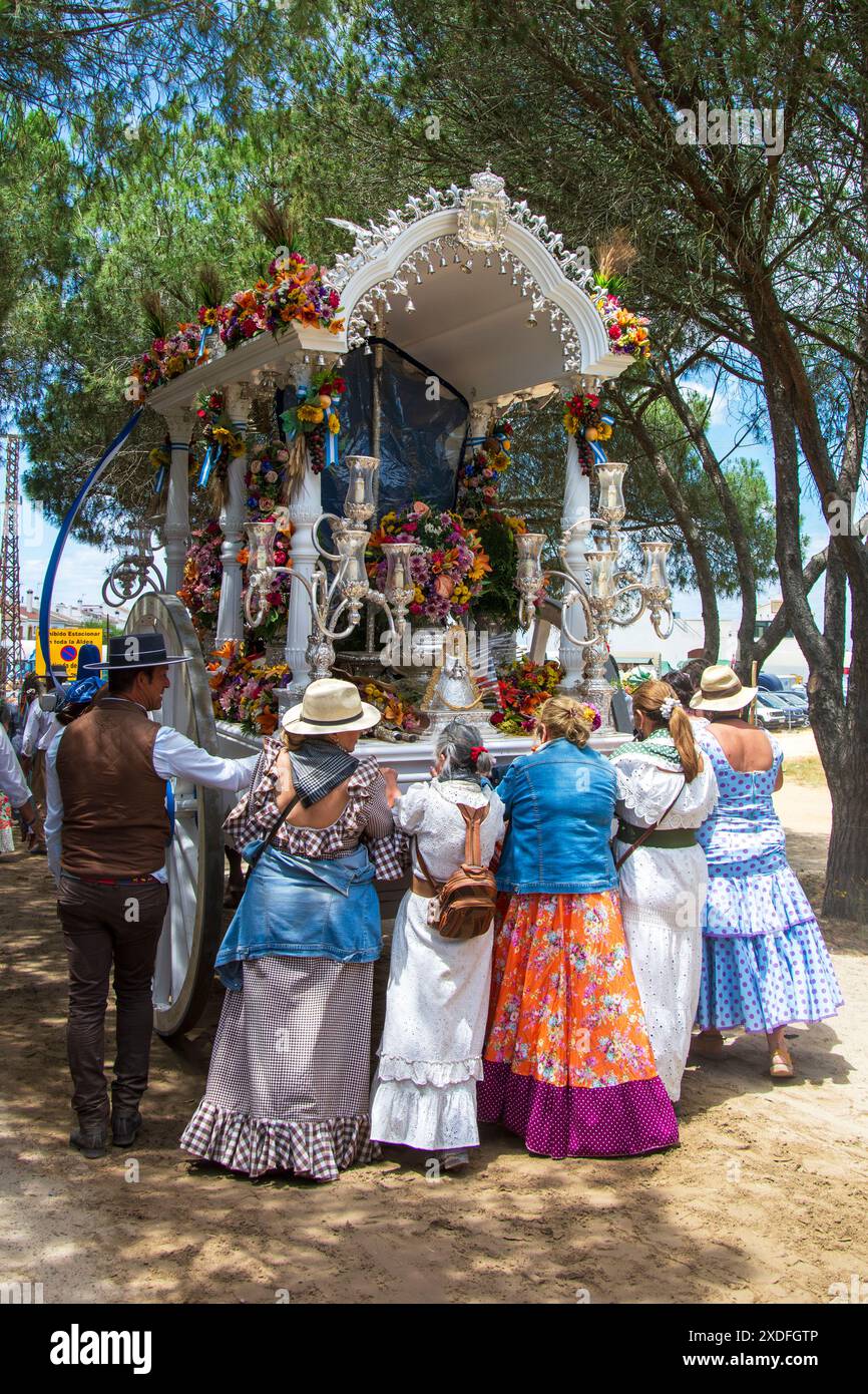 Group of pilgrims on foot following the ox cart at the entrance to ...