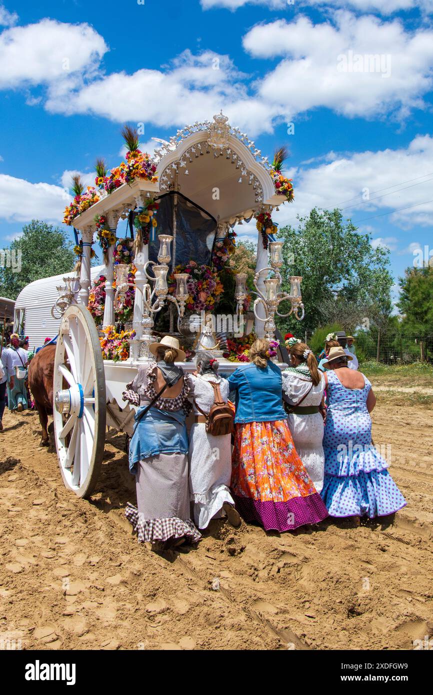 Group of pilgrims on foot following the ox cart at the entrance to ...