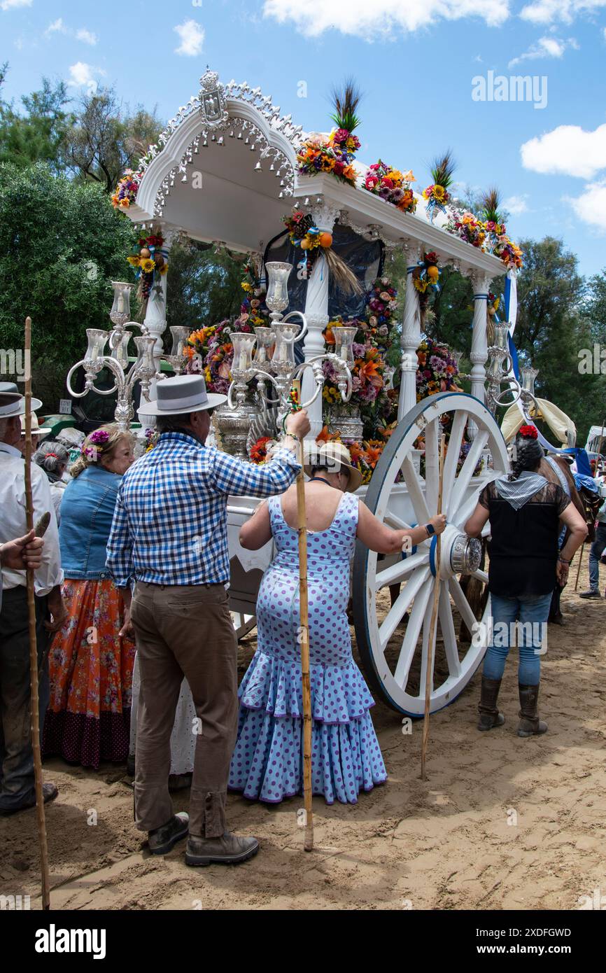 Group of pilgrims on foot following the ox cart at the entrance to ...