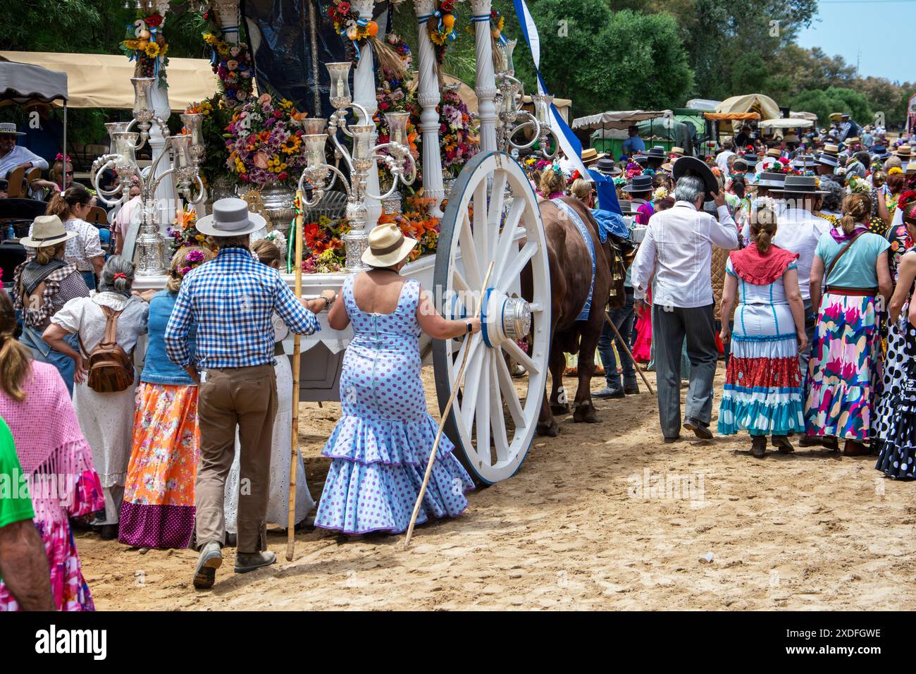 Group of pilgrims on foot following the ox cart at the entrance to ...