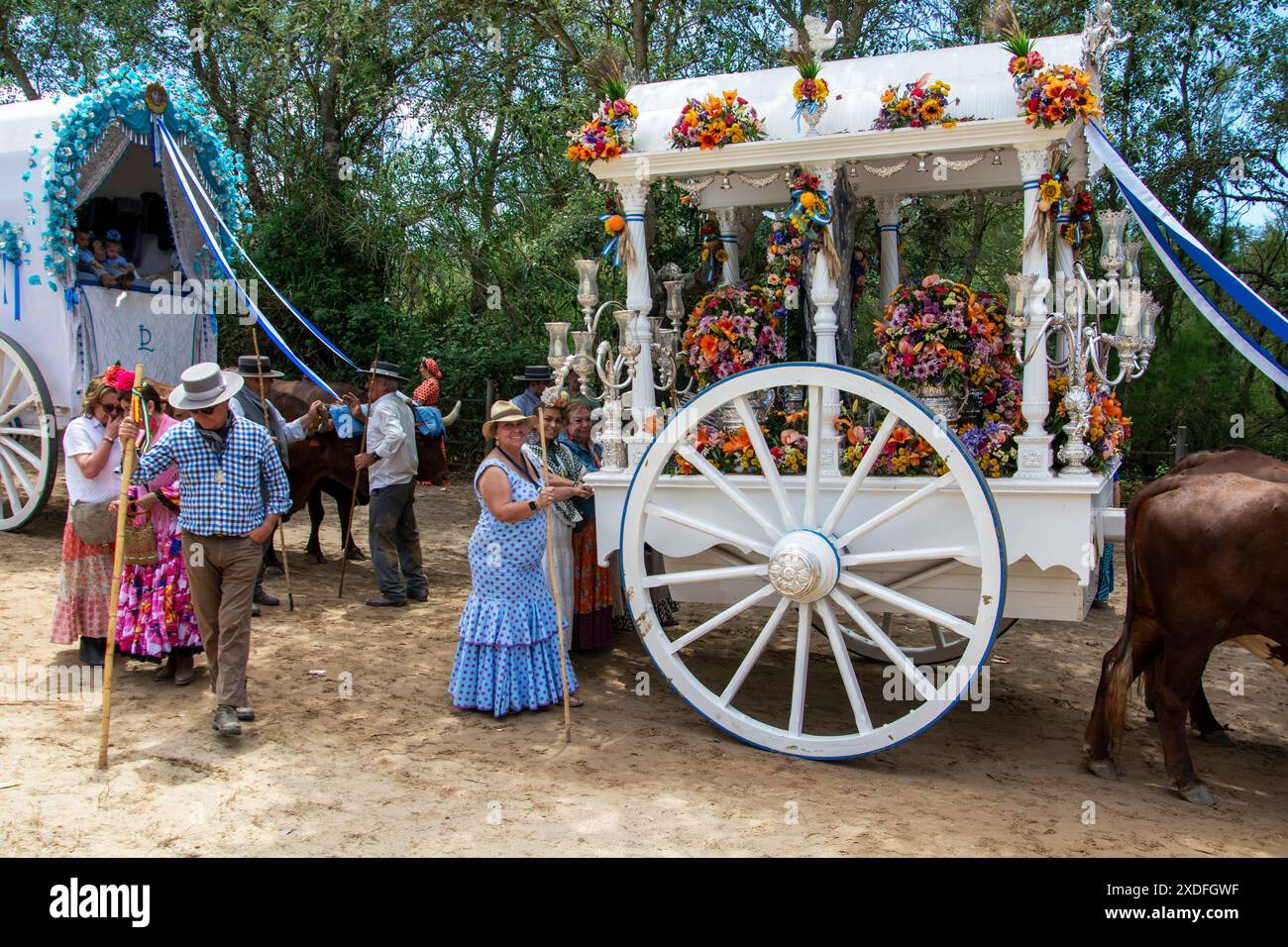 Group of pilgrims on foot following the ox cart at the entrance to ...