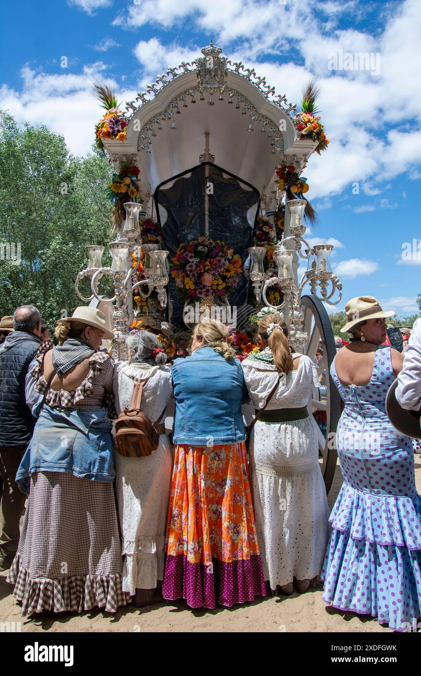 Group of pilgrims on foot following the ox cart at the entrance to ...