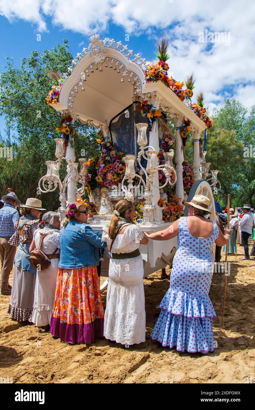 Group of pilgrims on foot following the ox cart at the entrance to ...