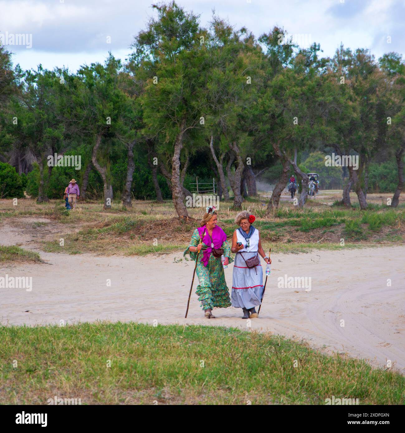 Older women dressed in flamenco dress making their way through the ...