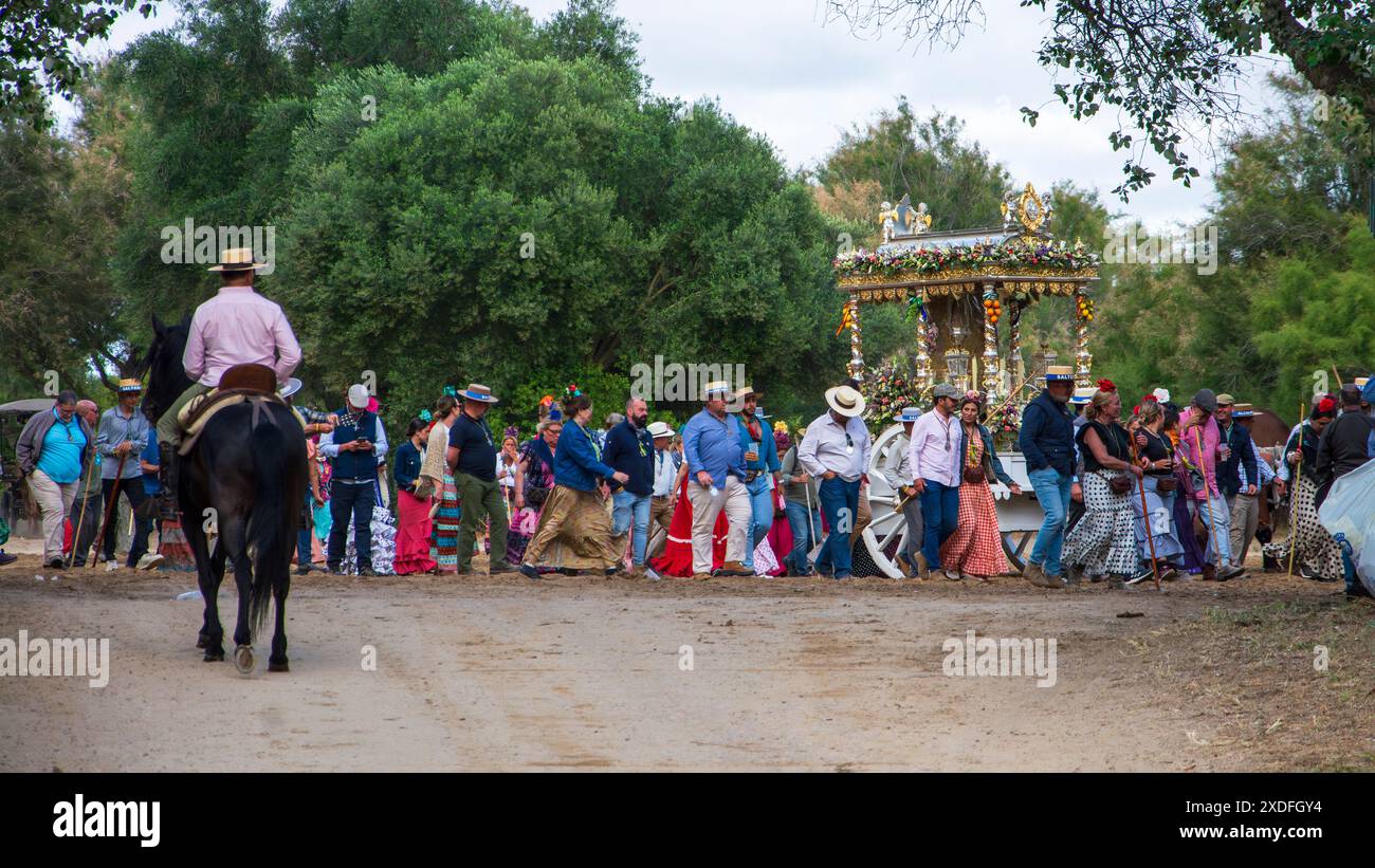 Group of pilgrims on foot following the ox cart at the entrance to ...
