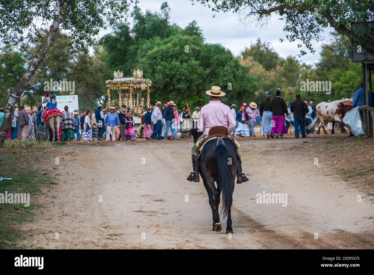 Group of pilgrims on foot following the ox cart at the entrance to ...