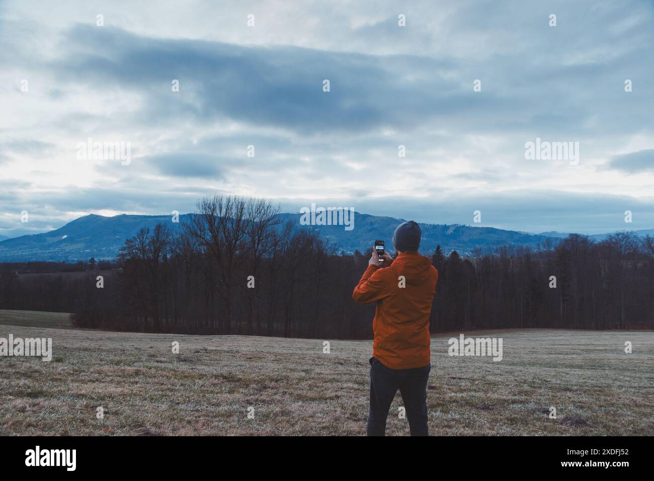 Adventurer takes photos on his mobile phone to capture the view ...