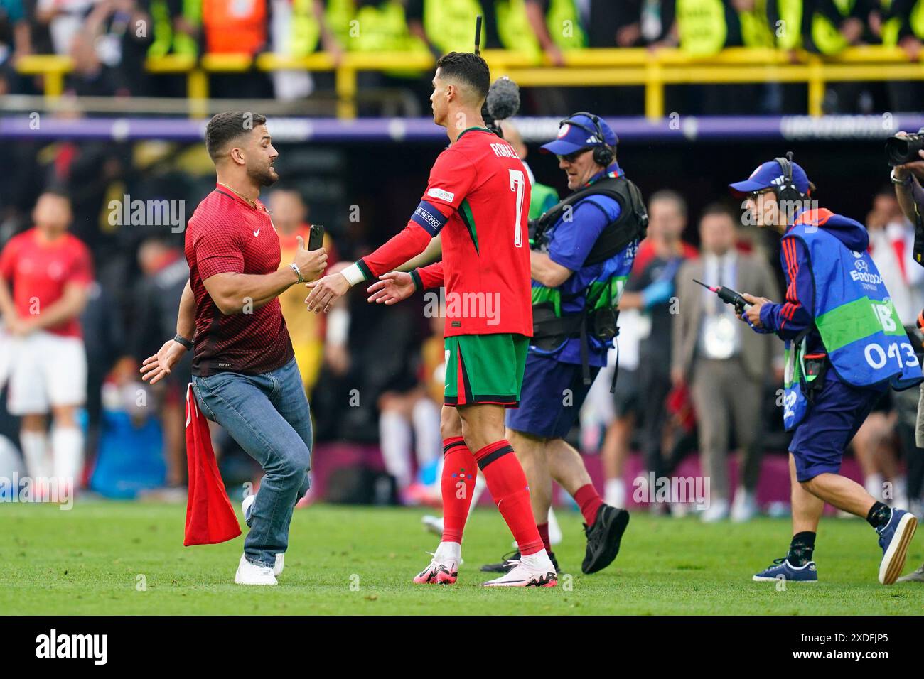Cristiano Ronaldo of Portugal and fan jumps onto the field during the ...
