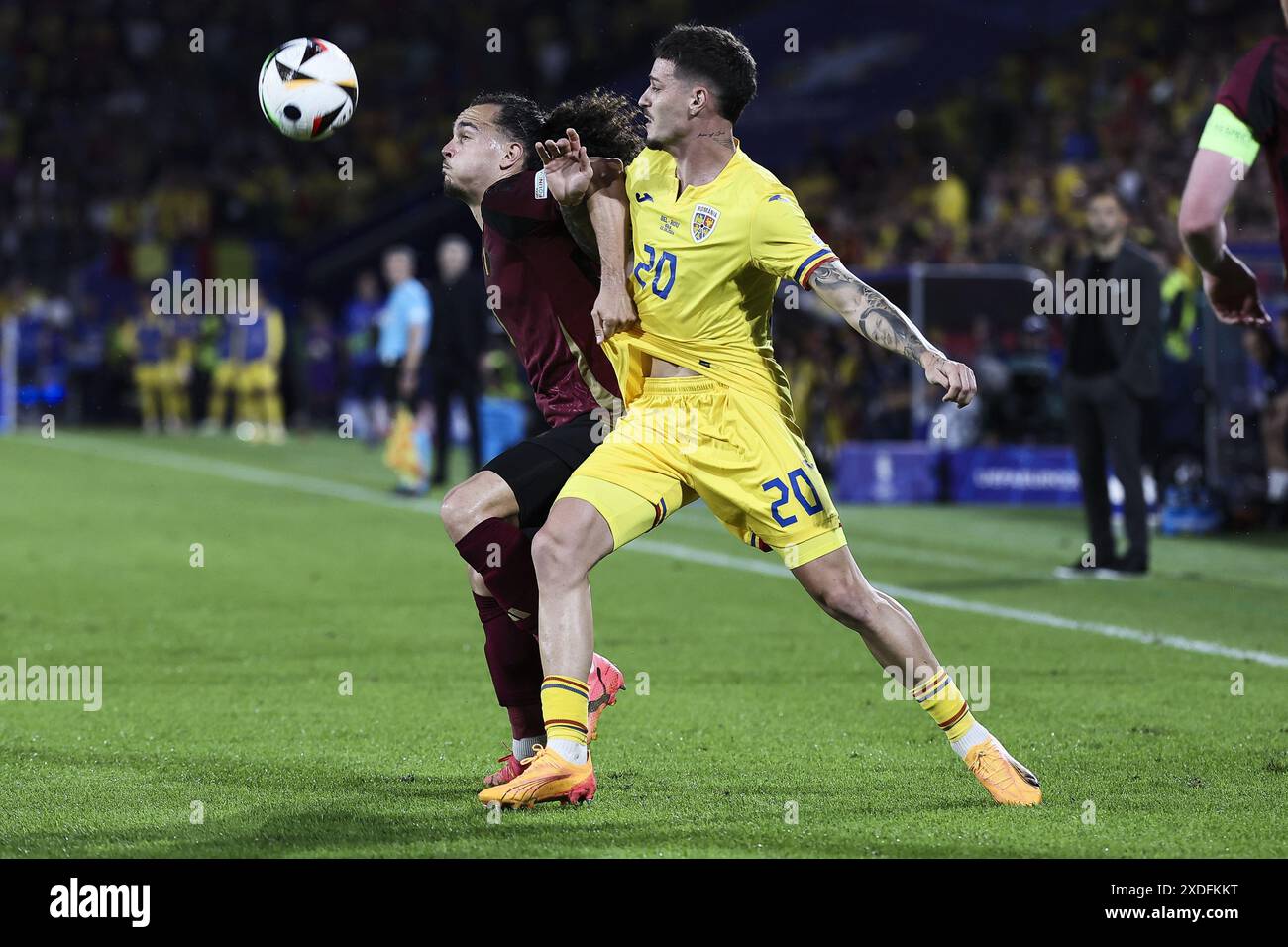 Belgium's Arthur Theate and Romania's Dennis Man fight for the ball ...