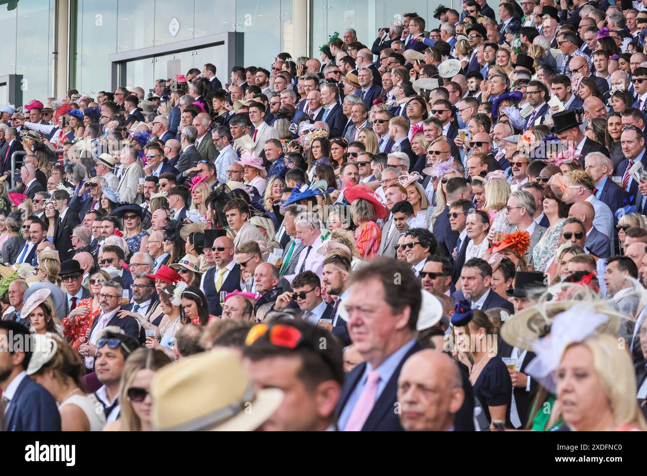 Racegoers and spectators watching the horse races from the stands at ...