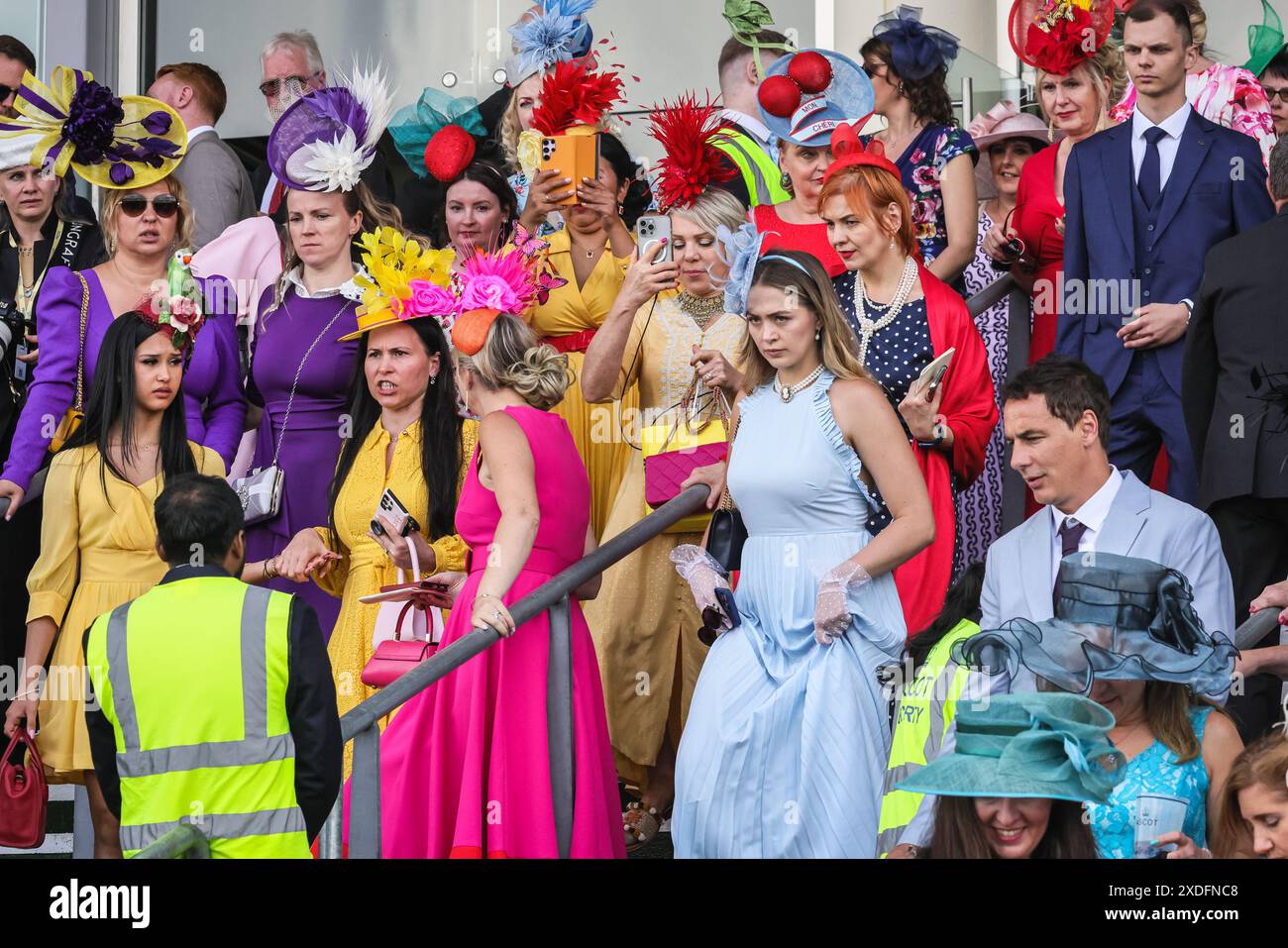 Racegoers and spectators watching the horse races from the stands at ...