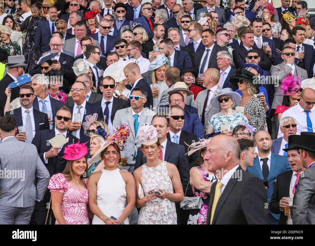 Racegoers and spectators watching the horse races from the stands at ...