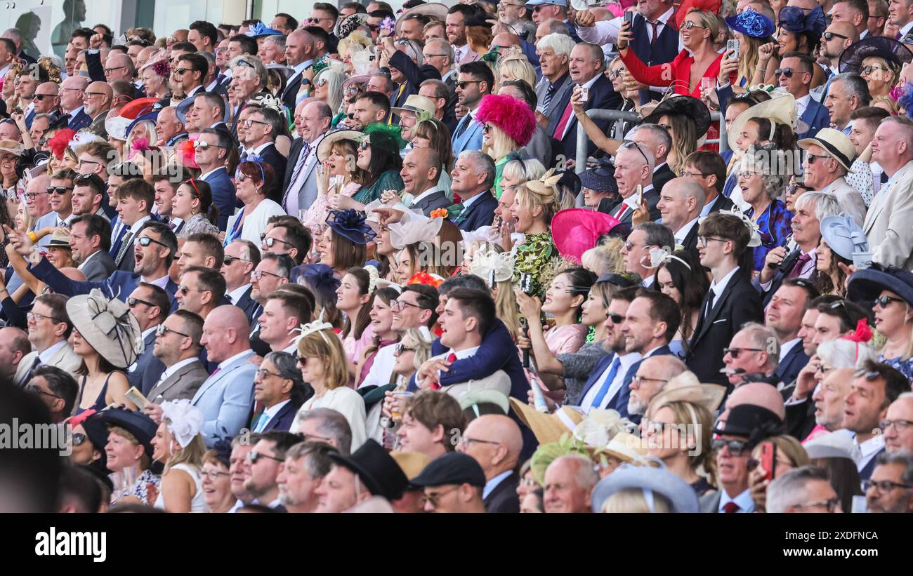 Racegoers and spectators watching the horse races from the stands at ...