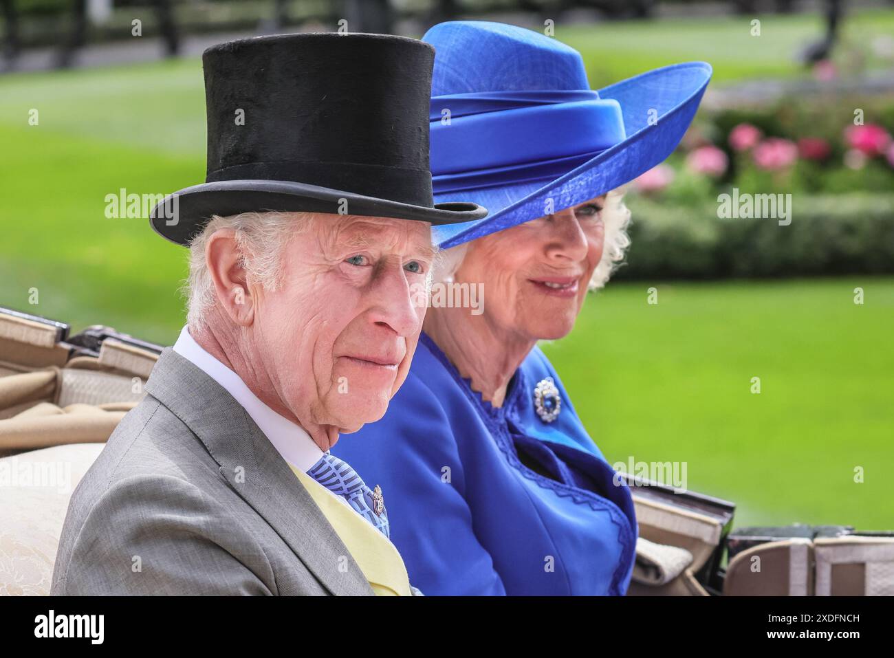 King Charles III and Queen Camilla smile and wave from their carriage ...