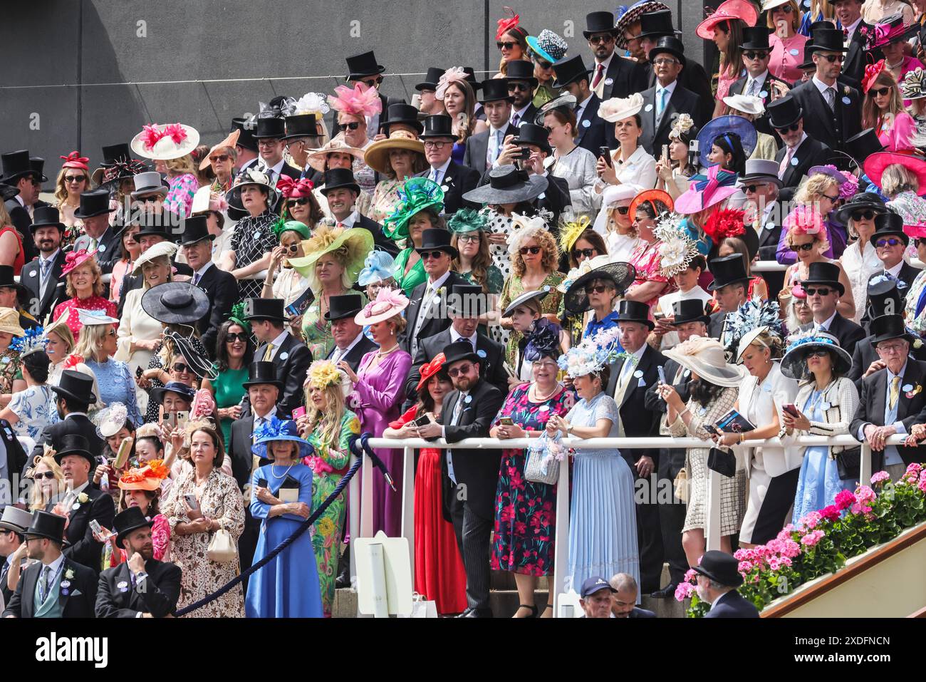 Racegoers and spectators watching the Royal Parade in hats and formal ...