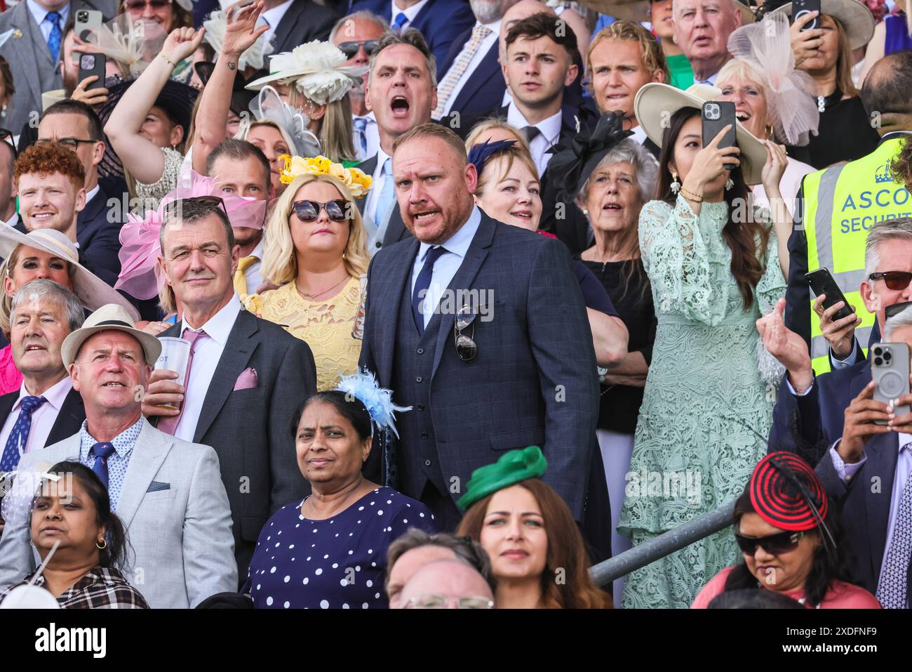 Racegoers and spectators watching the horse races from the stands at ...
