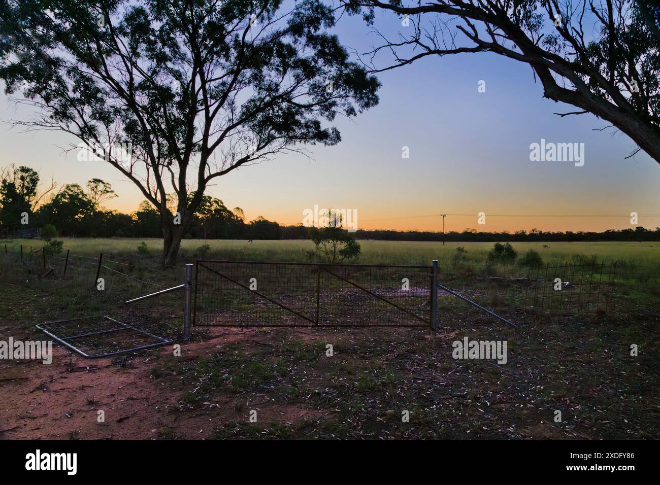 Gate and fense around cattle farm paddock in Western plains of ...