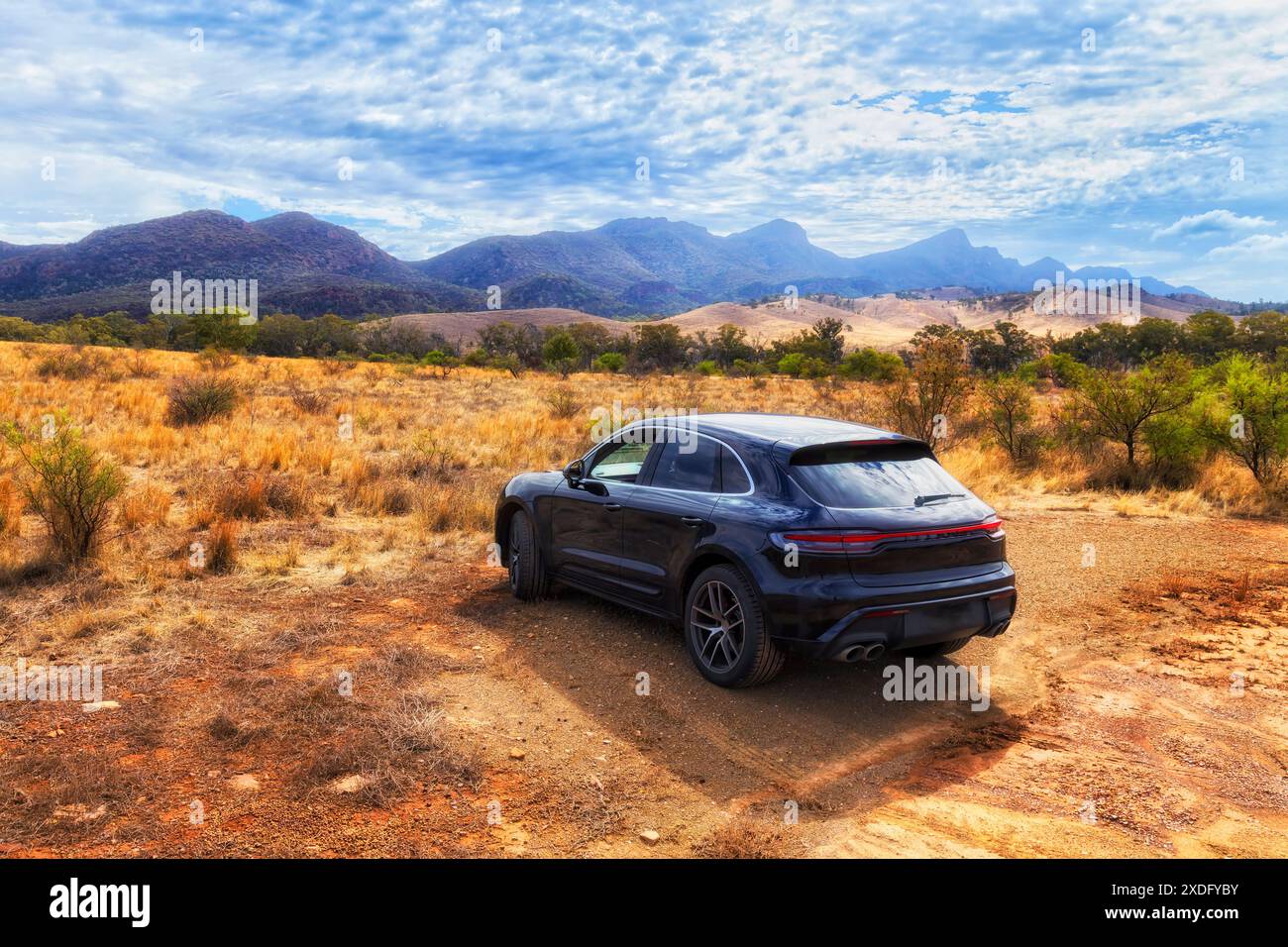 SUV off road driving car at a lookout overlooking Wilpena Pound rock ...