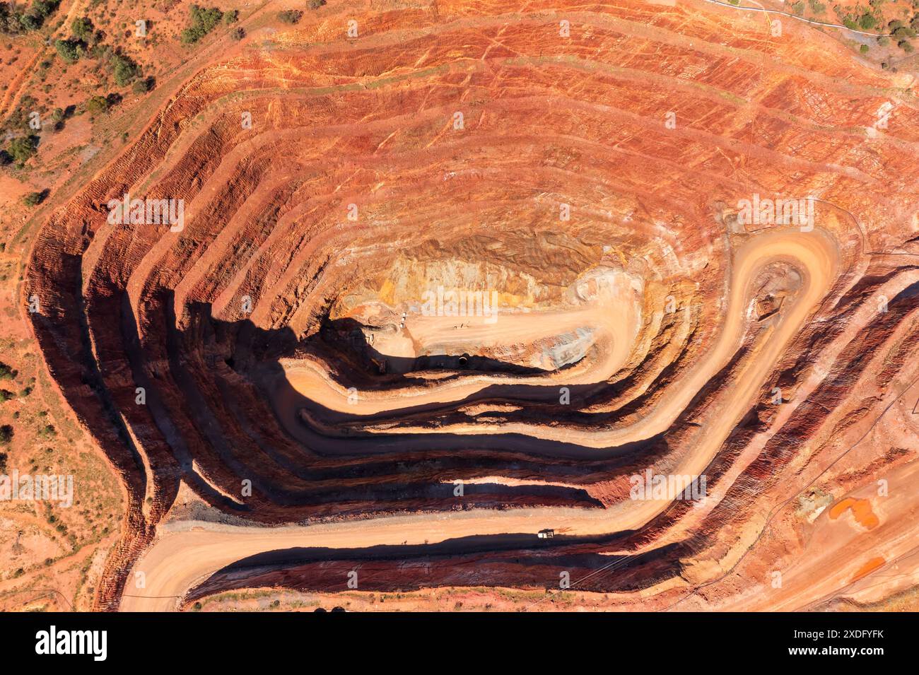 Open pit deep excavated copper mine in Cobar town of Australia - resource mining industry aerial ...