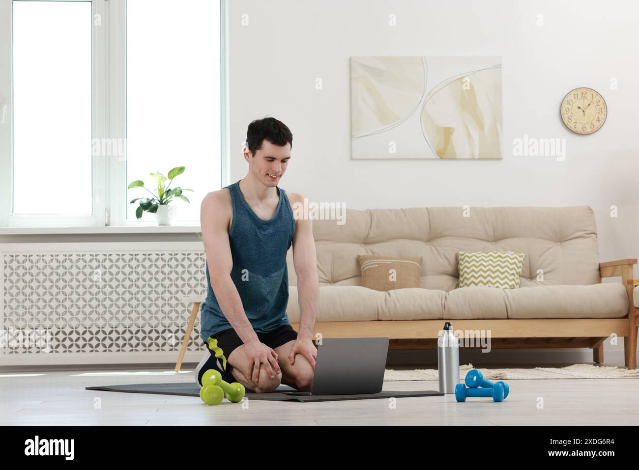 Online fitness trainer. Man watching tutorial on laptop indoors Stock ...