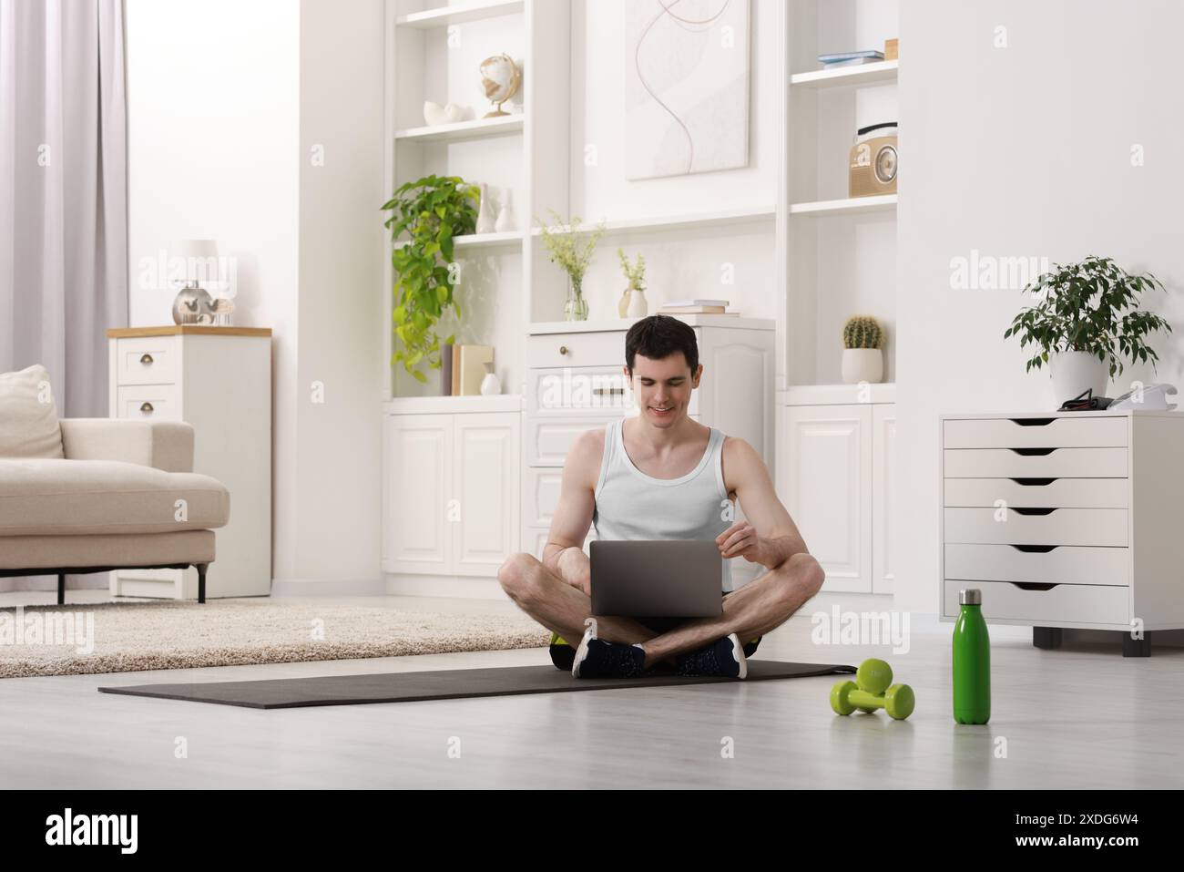 Online fitness trainer. Man watching tutorial on laptop indoors Stock ...