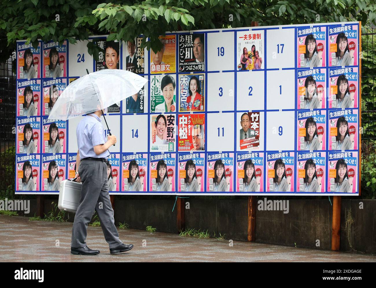 Tokyo, Japan. 21st June, 2024. A man watches posters of Tokyo ...