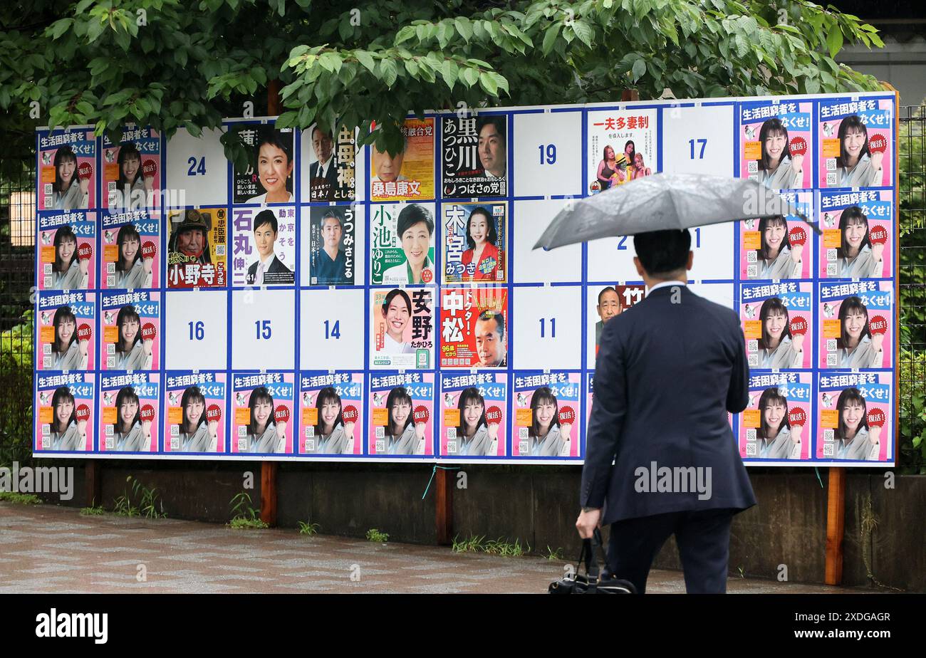Tokyo, Japan. 21st June, 2024. A man watches posters of Tokyo ...