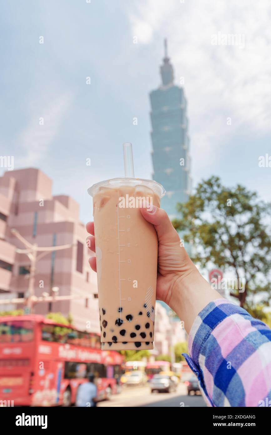 Closeup view of female hand holding traditional Taiwanese bubble milk ...
