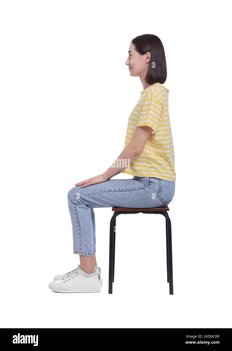 Woman with good posture sitting on chair against white background Stock ...