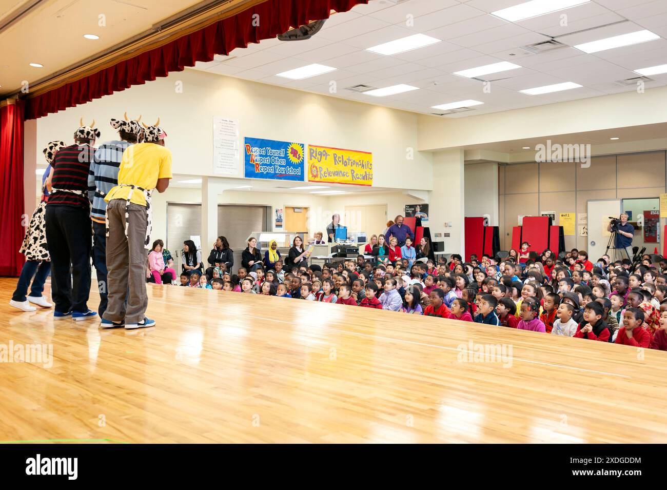 Elementary school students watching a performance in school Stock Photo ...
