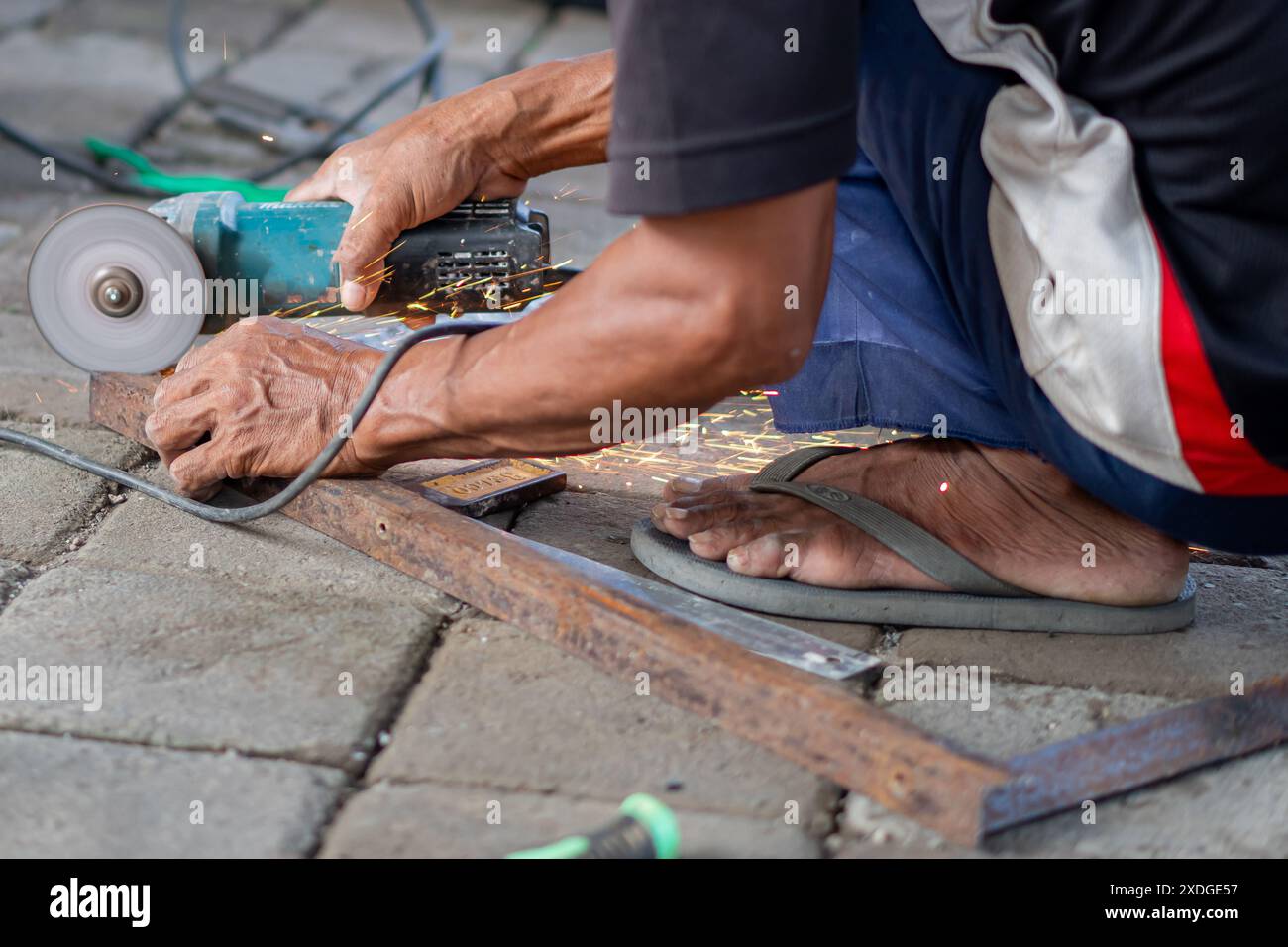 Craftsman using angle grinder kneeling on hi-res stock photography and ...