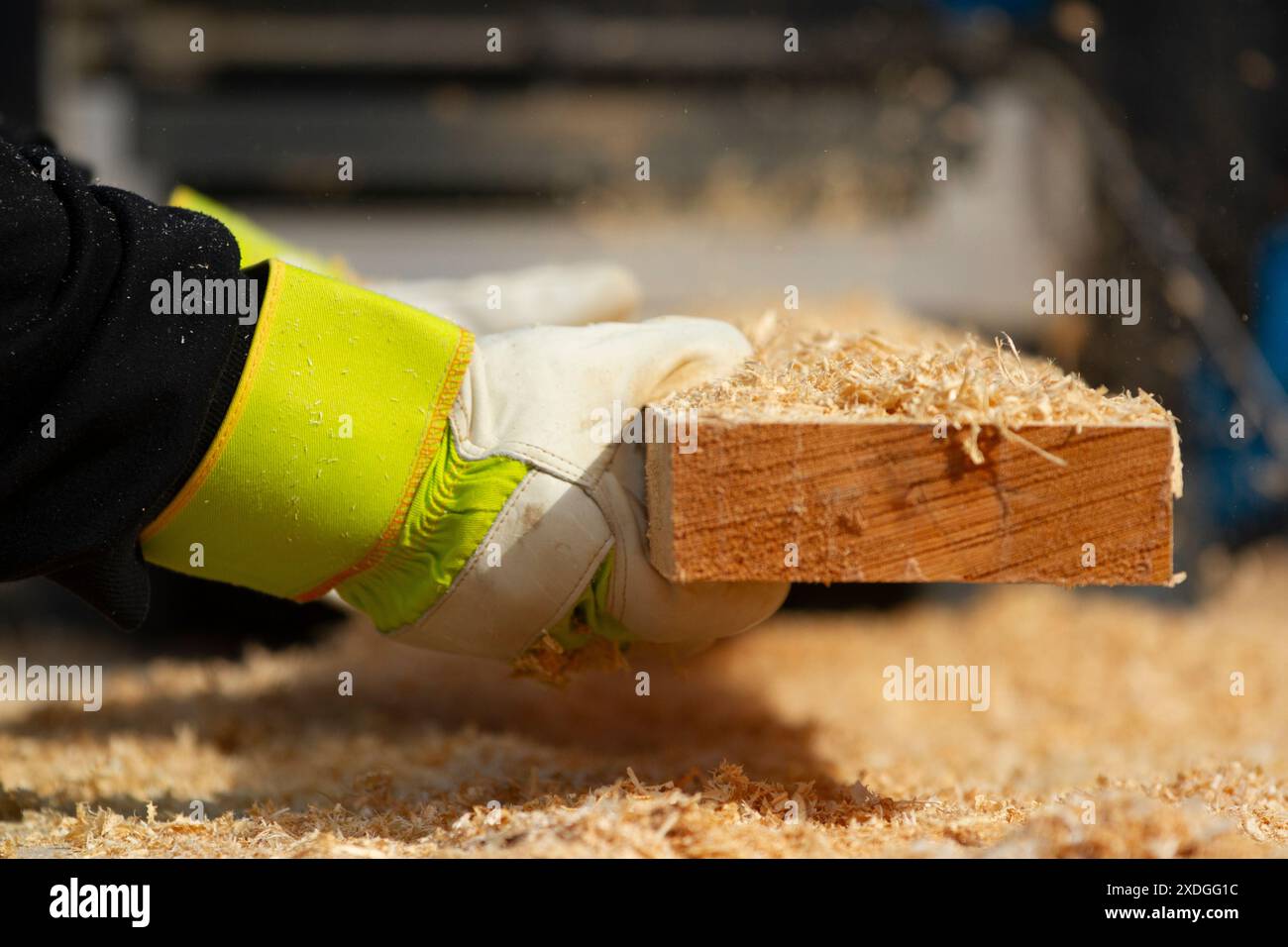 Close of photograph of a person with safety gloves retrieving a piece ...