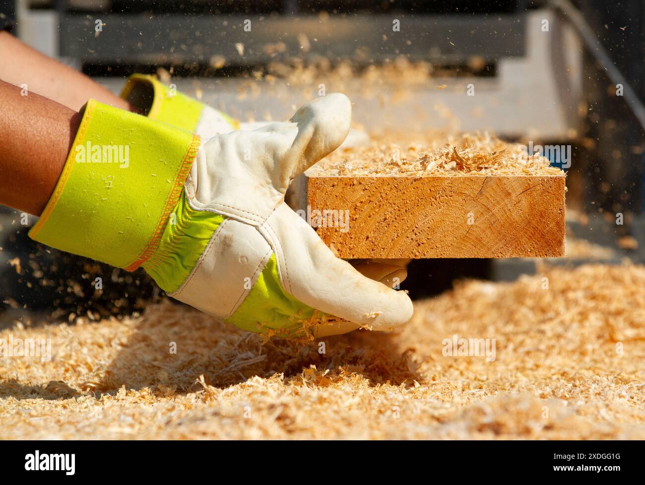 Close of photograph of a person with safety gloves retrieving a piece ...