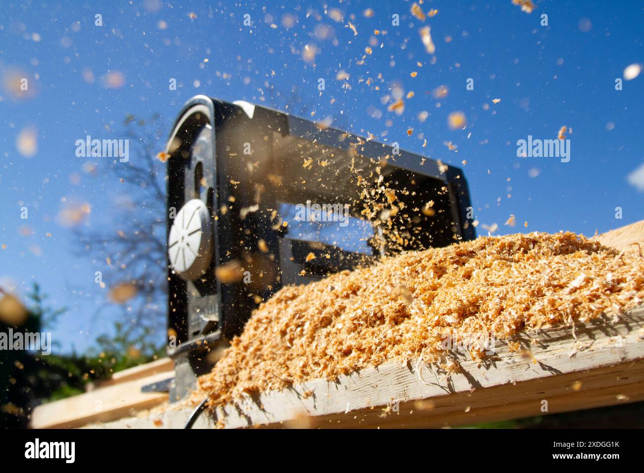 Sawdust is dispersed into the air as a 2x4 makes its way through a ...