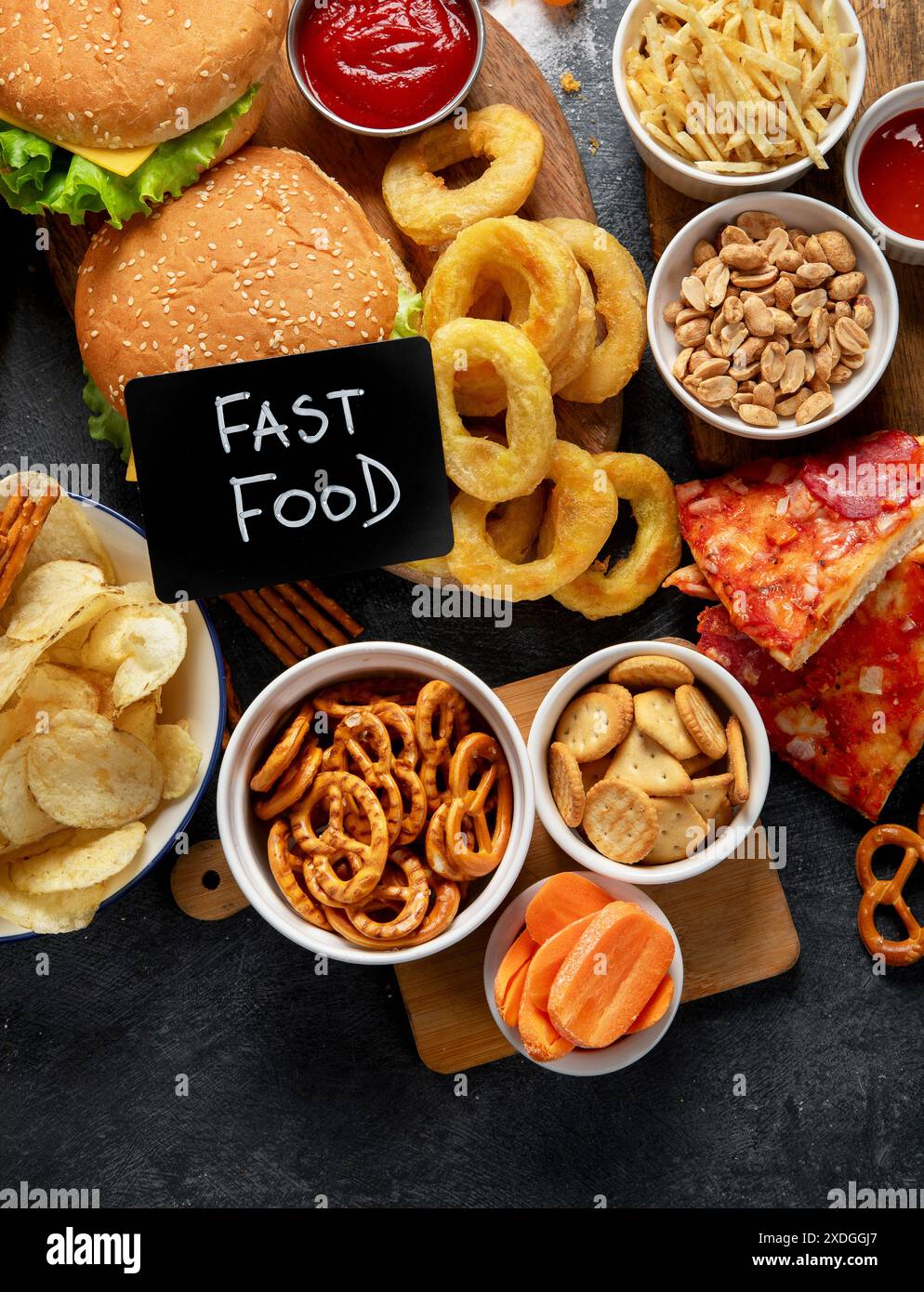 Large table of assorted take out food such as pizza, french fries ...